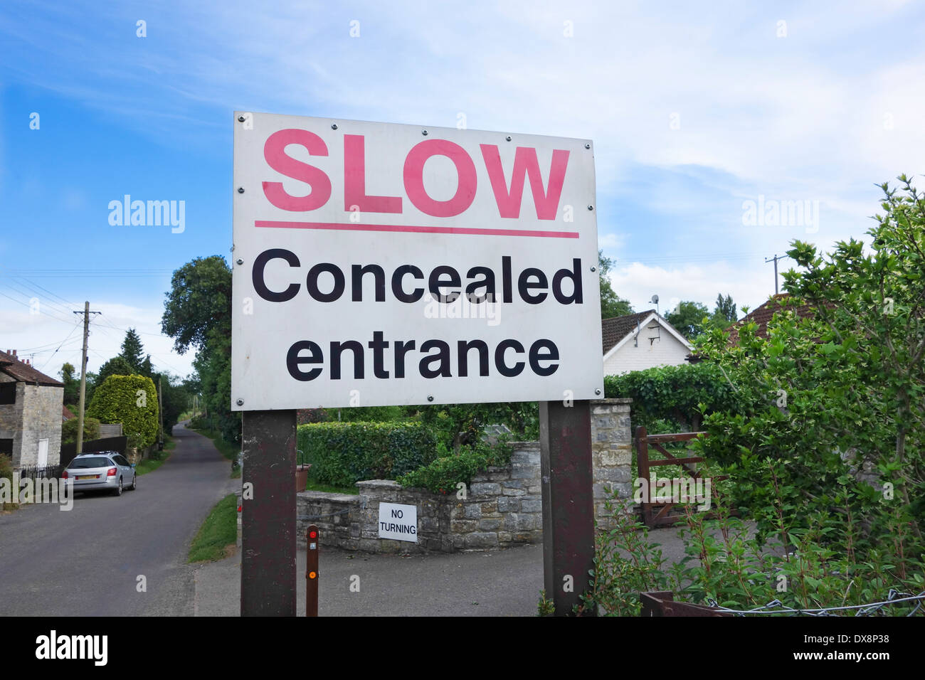 Road Sign Slow Concealed Entrance Stock Photo - Alamy