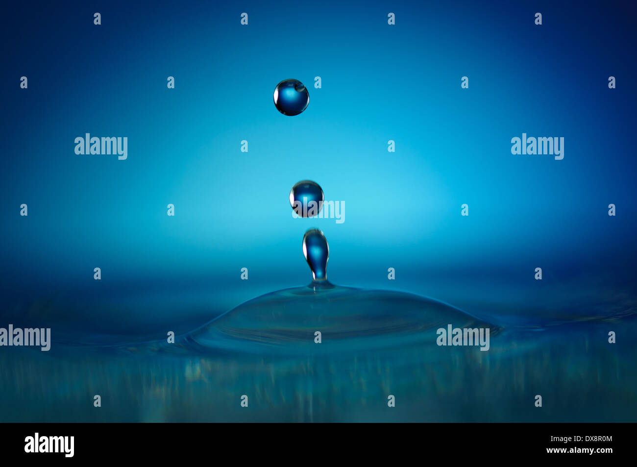 Three blue water drops forming abstract figure without splashes Stock ...