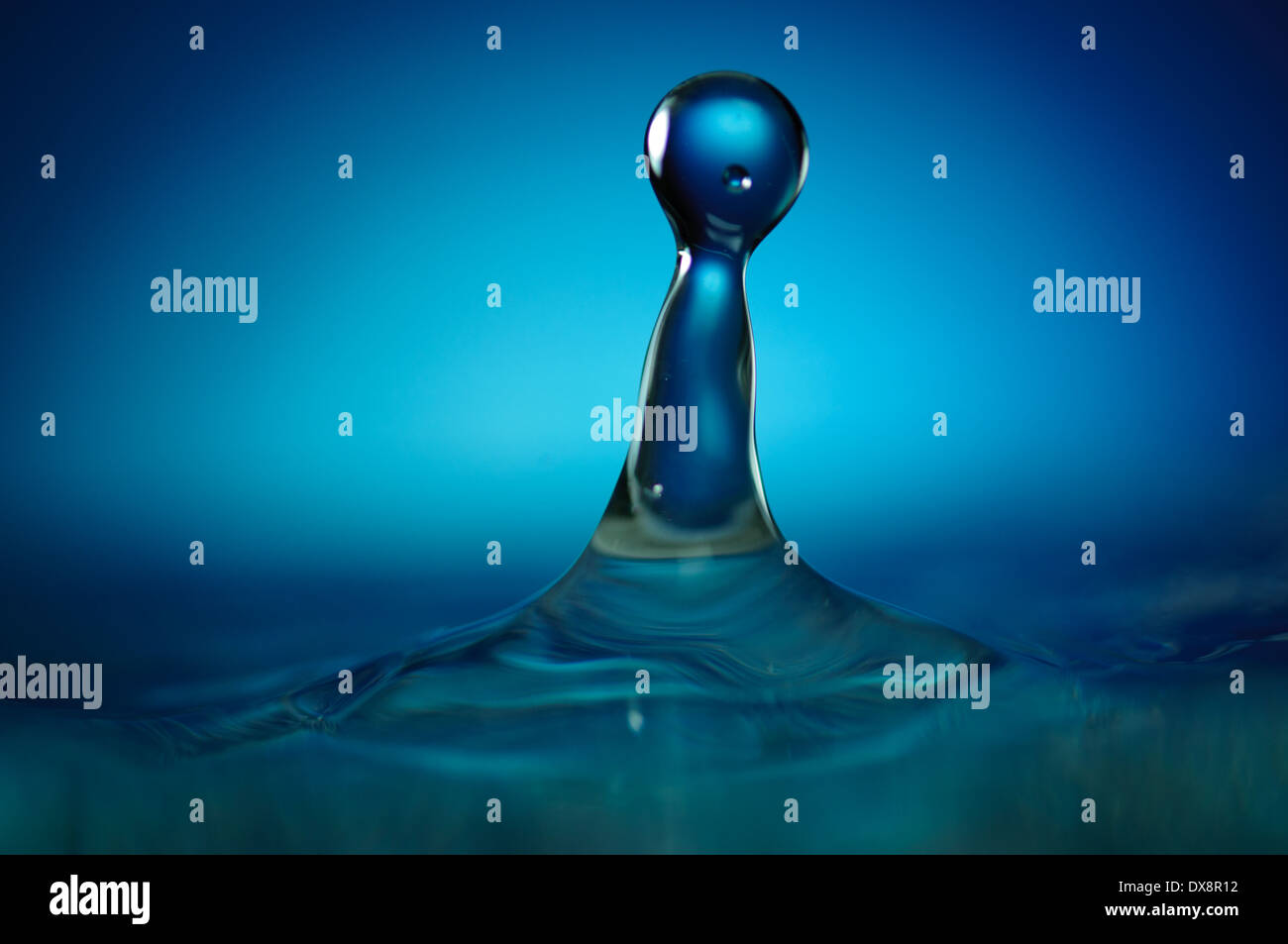 Blue water drop forming abstract figure without splashes Stock Photo ...