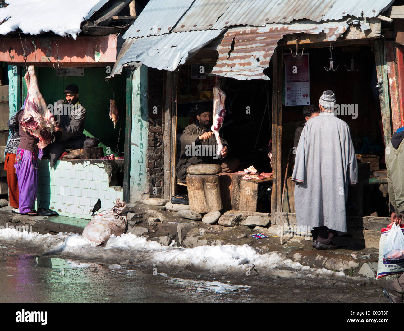 India, Kashmir, Srinagar, meat stall in bazaar, men wearing Pheran ...