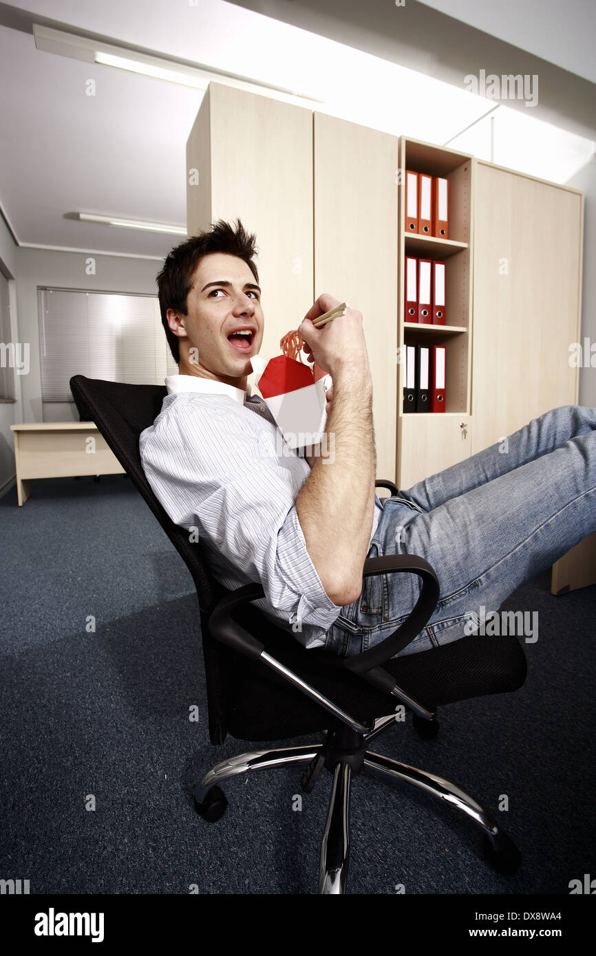 Office worker eating Chinese food at desk Stock Photo - Alamy