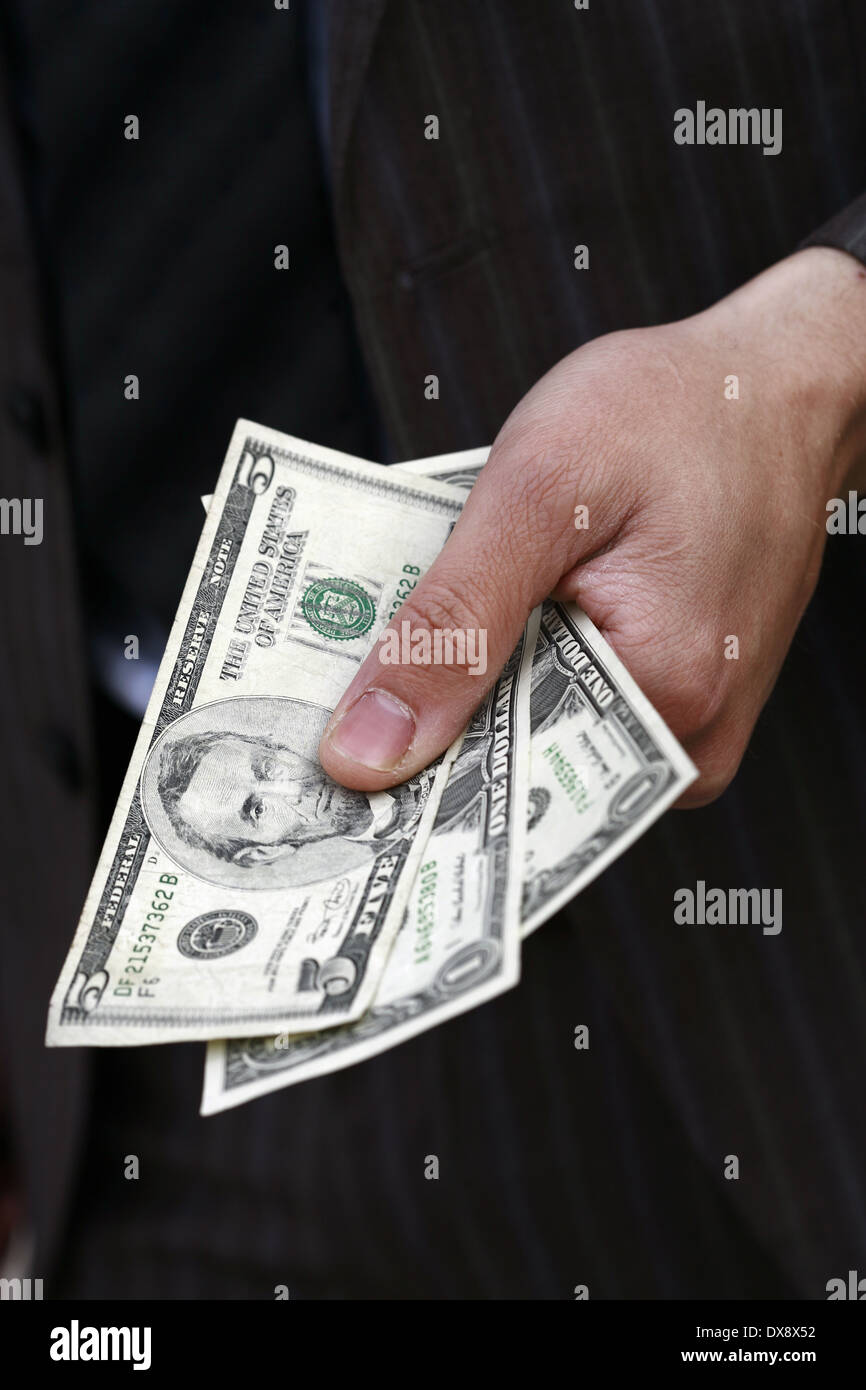 Closeup of hand holding dollars Stock Photo - Alamy
