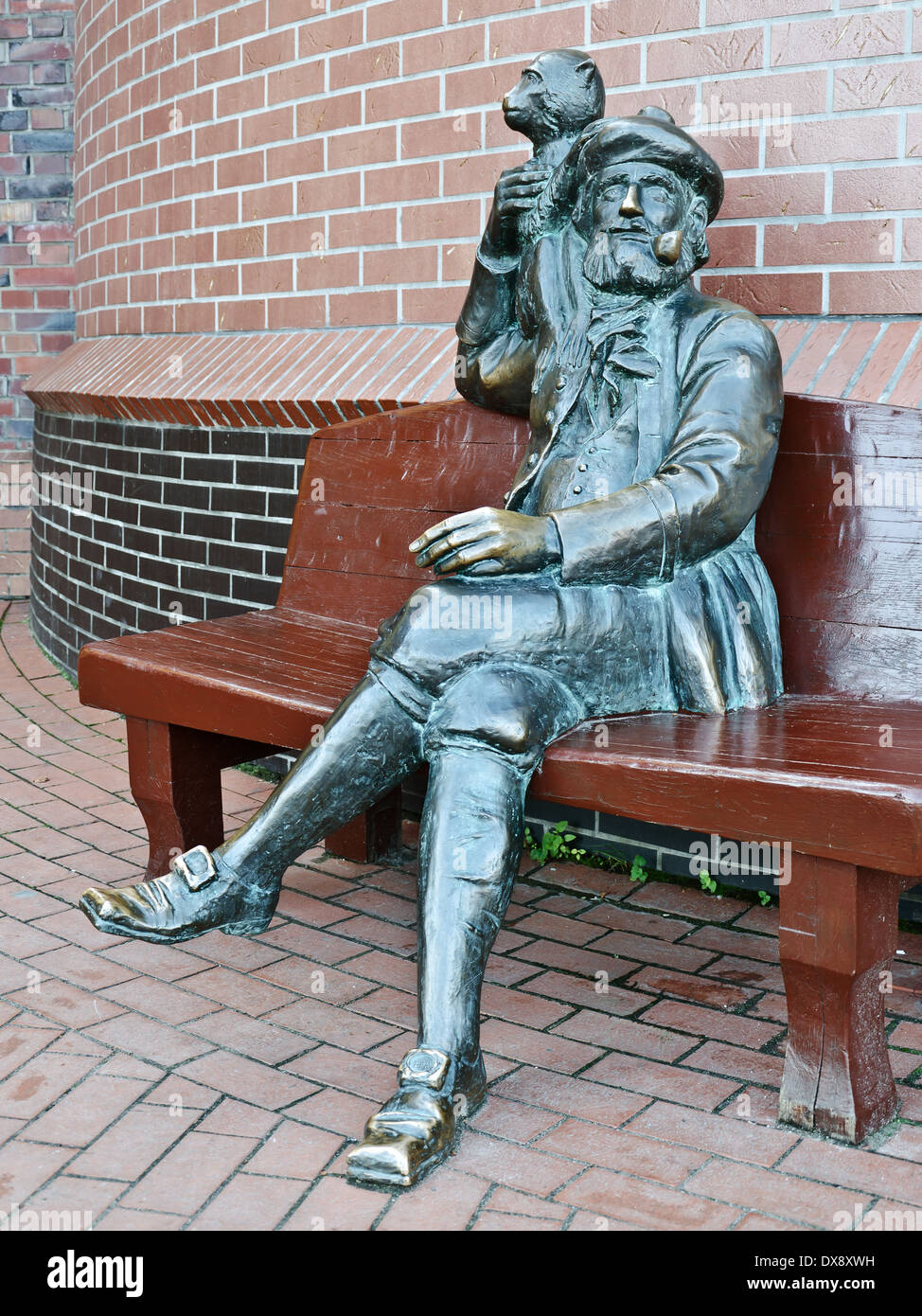 Sculpture of the old skipper with a monkey. Fishing village ...