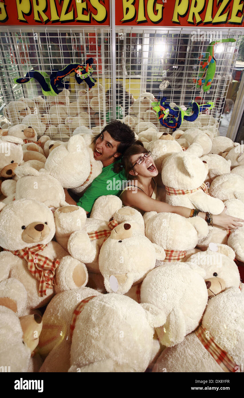 Teenage couple among teddy bears in arcade Stock Photo - Alamy