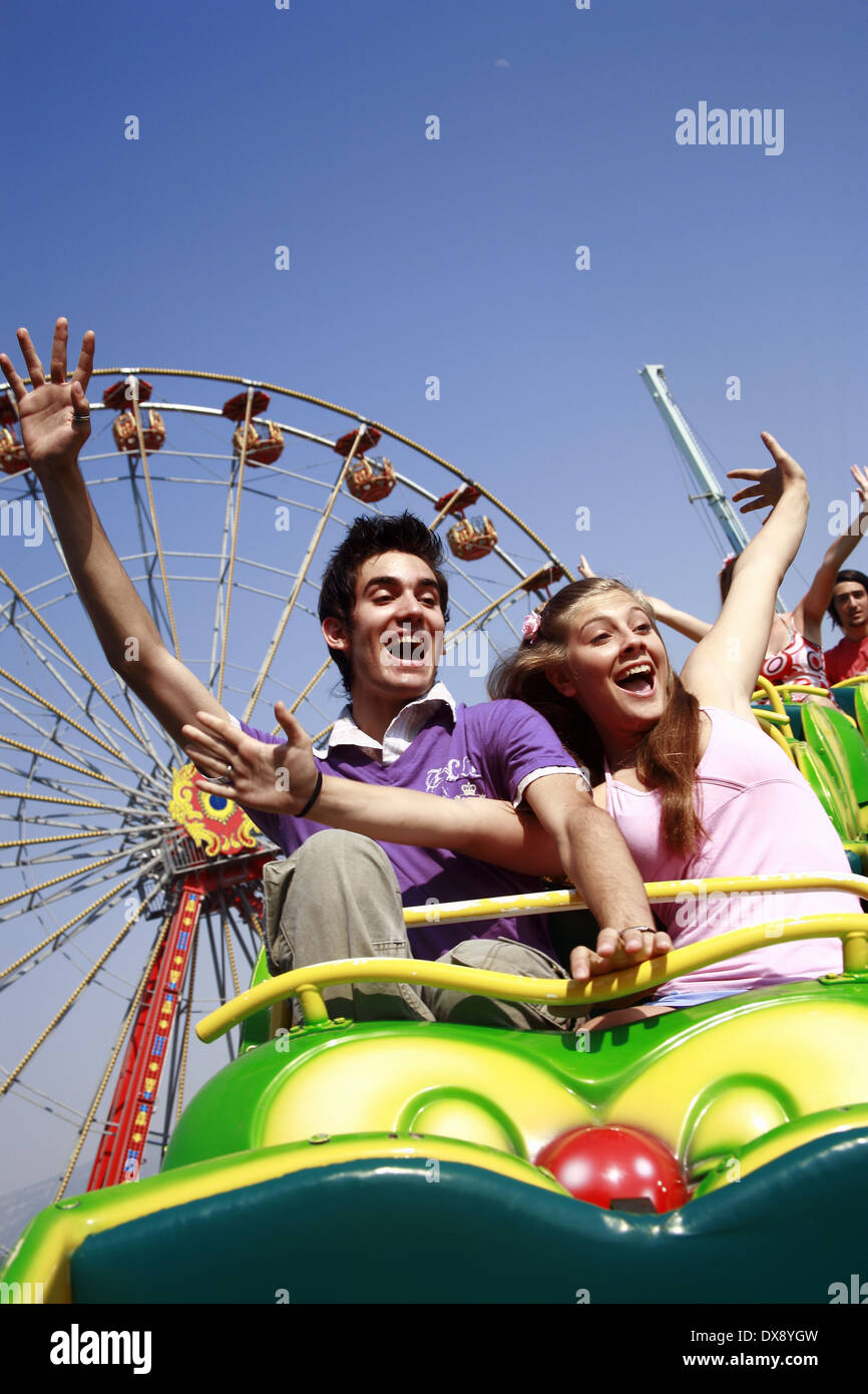 Teenage couple on amusement park ride Stock Photo - Alamy