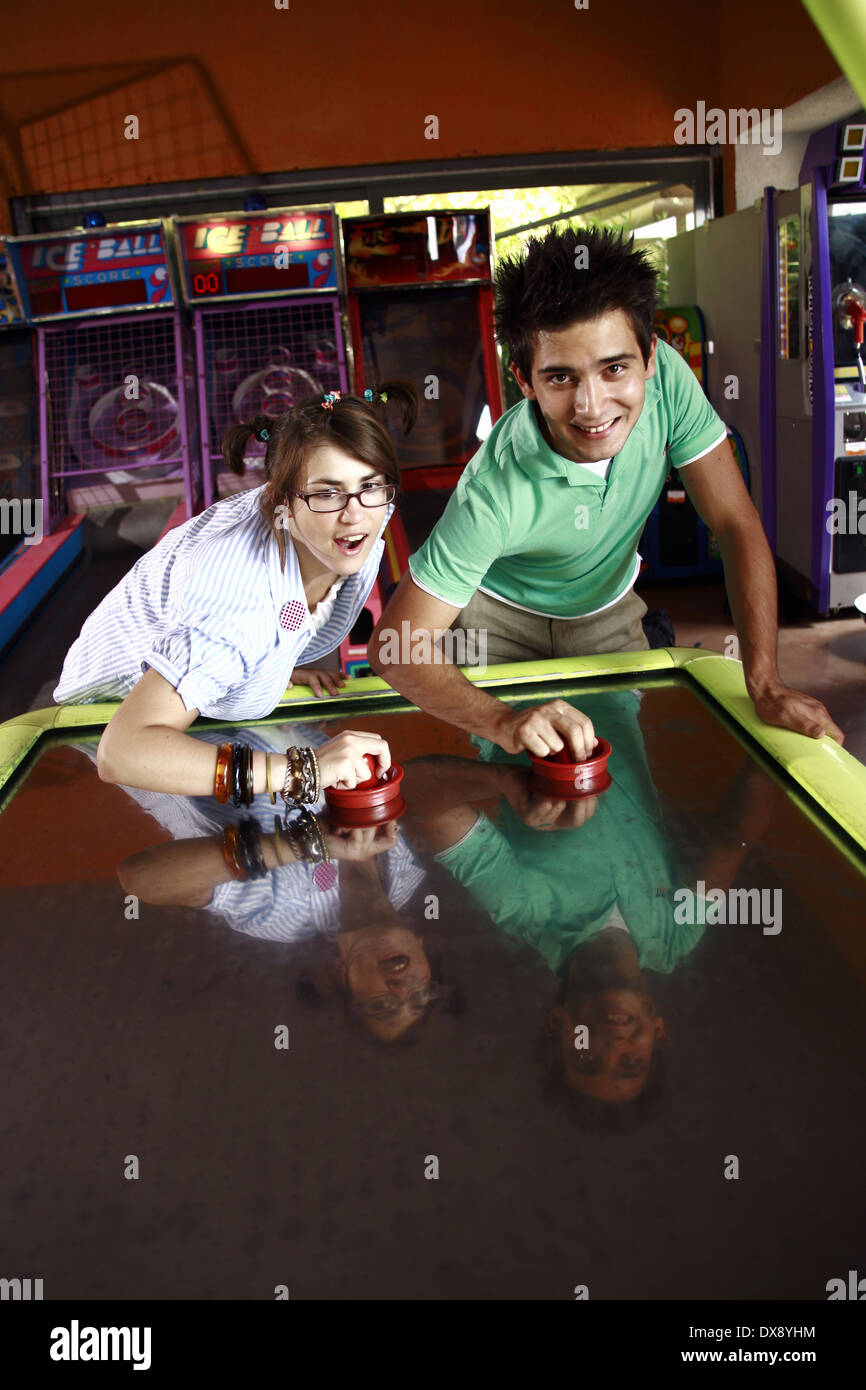 Teenage couple playing game in arcade Stock Photo - Alamy