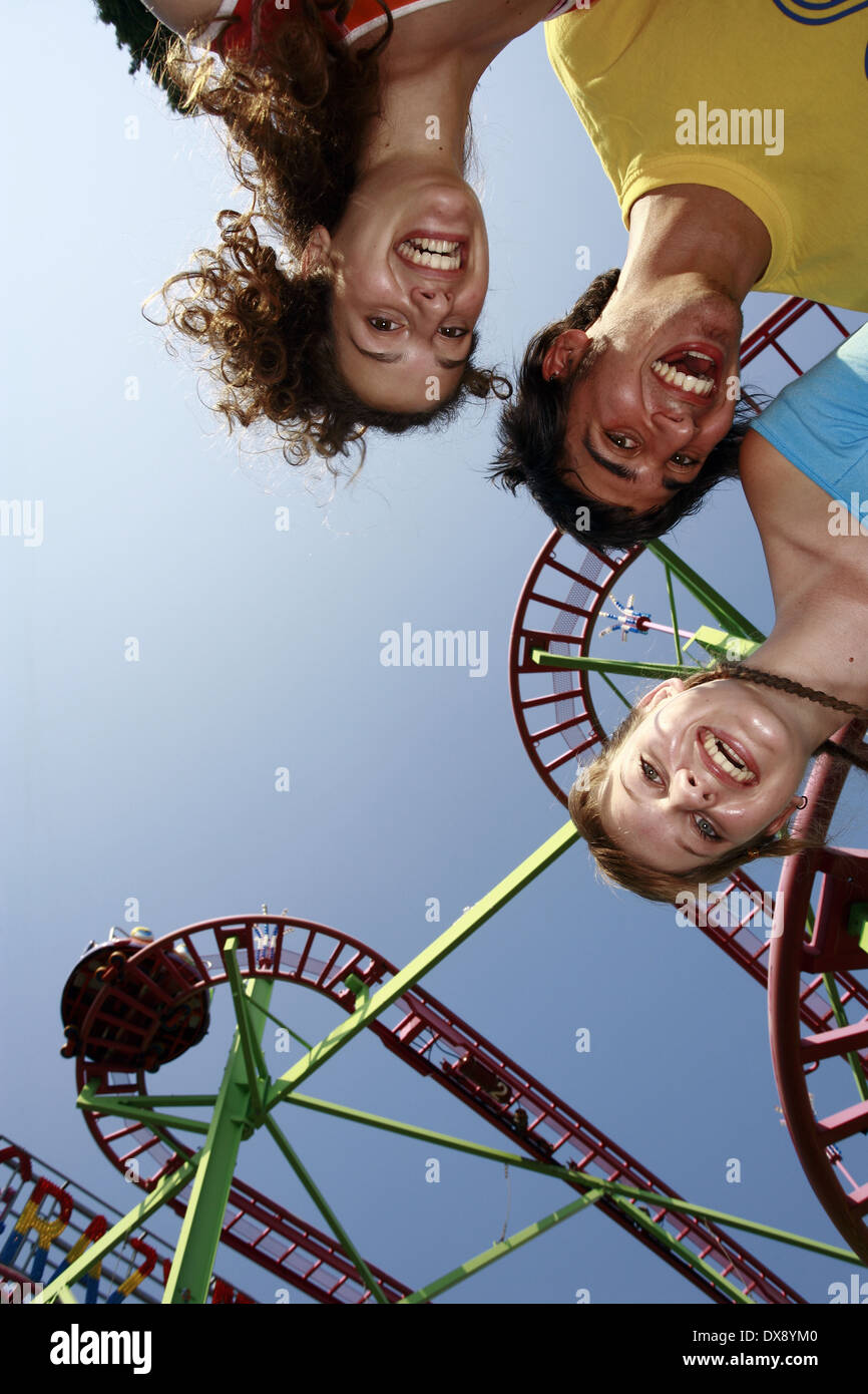 Teenagers posing at roller coaster at amusement park Stock Photo - Alamy