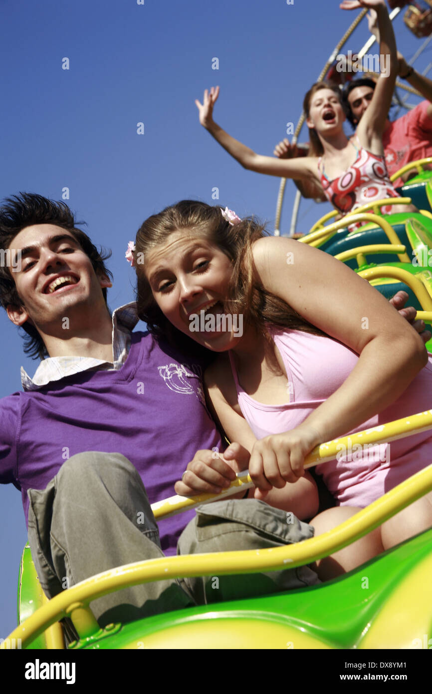 Teenage couple on amusement park ride Stock Photo - Alamy