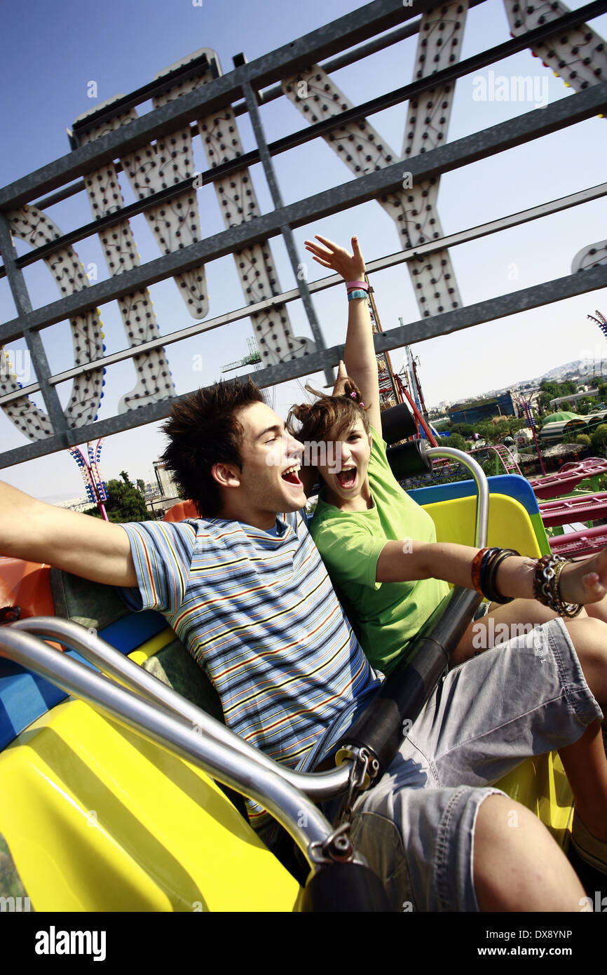 Teenage couple on amusement park ride Stock Photo - Alamy