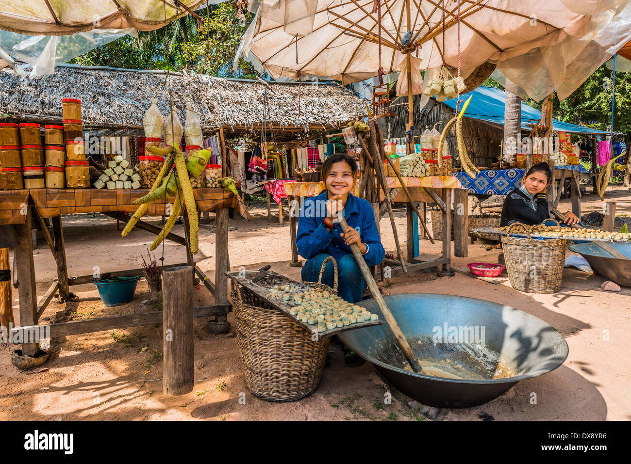 Angkor, Cambodia - January 2, 2014: girl making and selling sugar cane ...