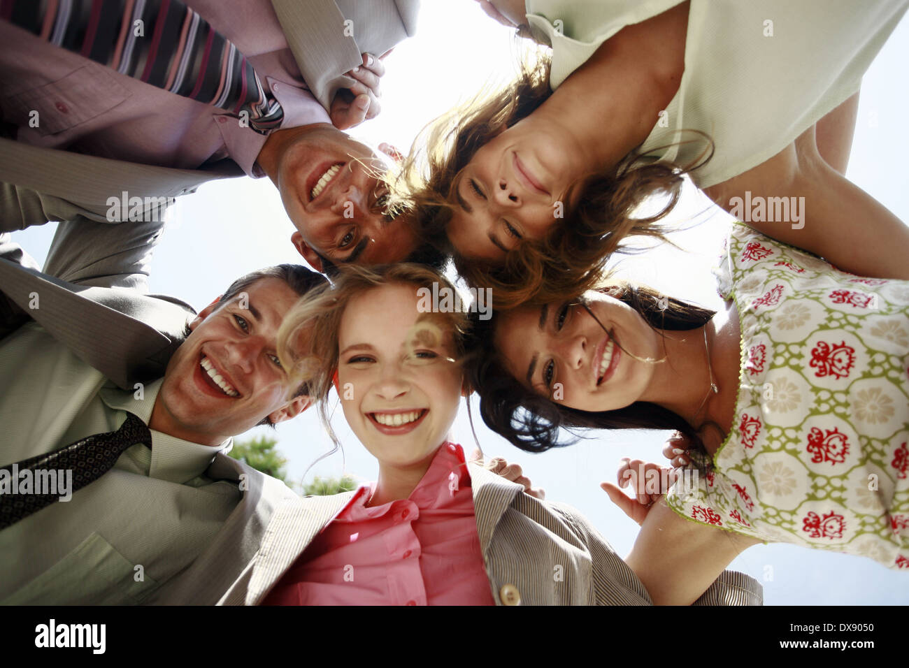 Group of business people with heads together Stock Photo - Alamy