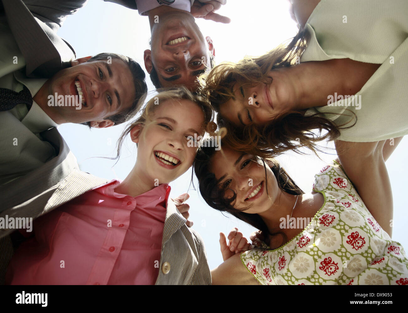 Group of business people with heads together Stock Photo - Alamy