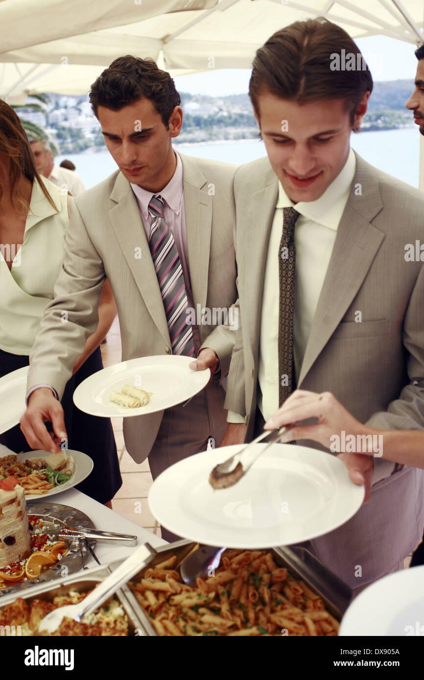 Businessmen at lunch buffet Stock Photo - Alamy