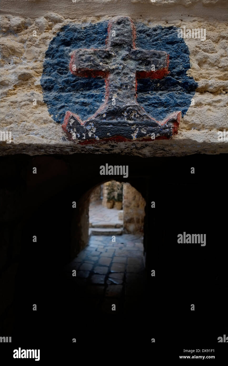 A cross embedded into a stone portal marking a Christian house in Bab ...