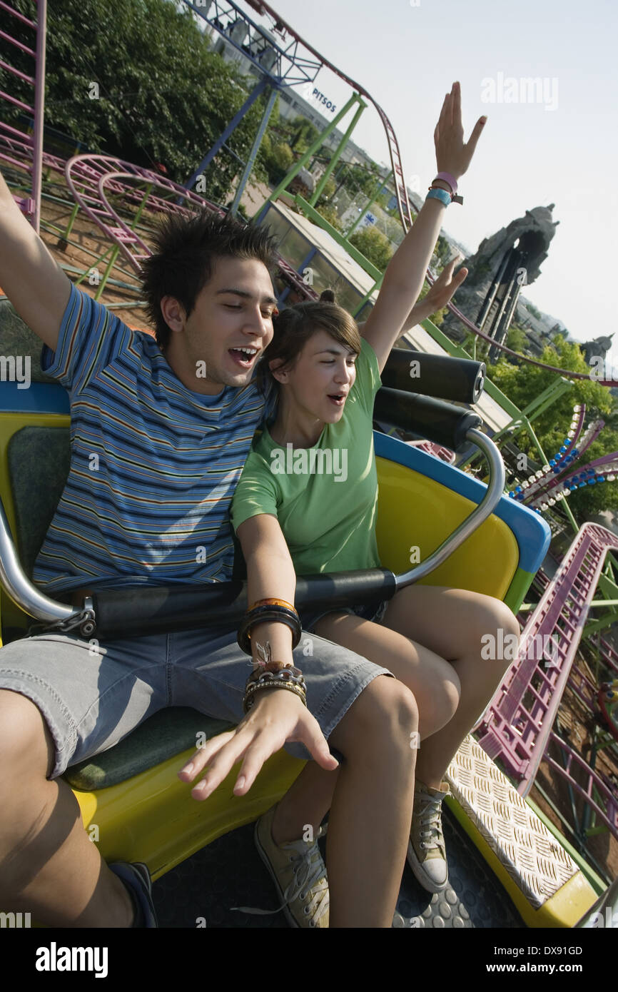 Teenage couple on amusement park ride Stock Photo - Alamy
