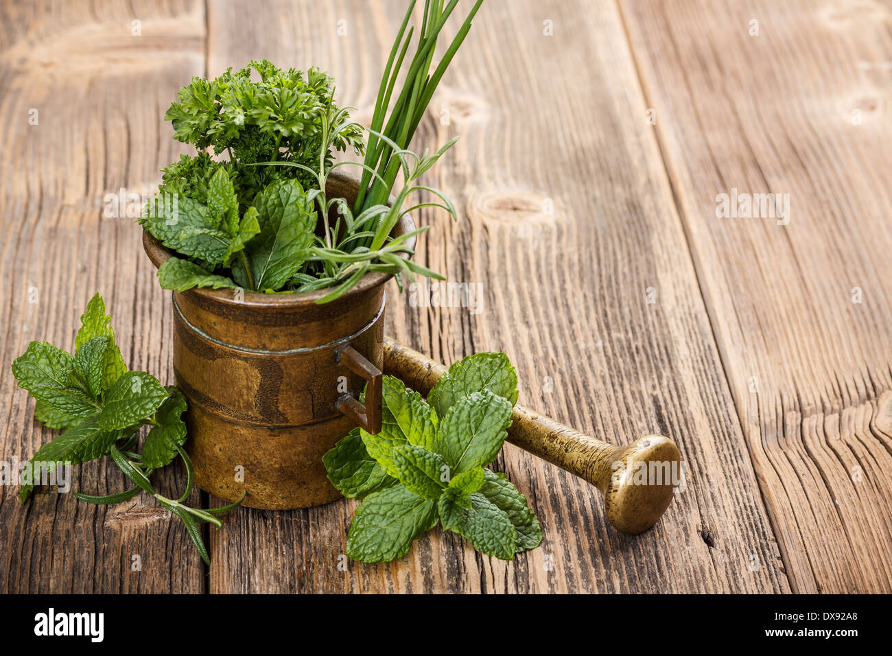 Herbs with antique mortar on rustic wooden background Stock Photo - Alamy