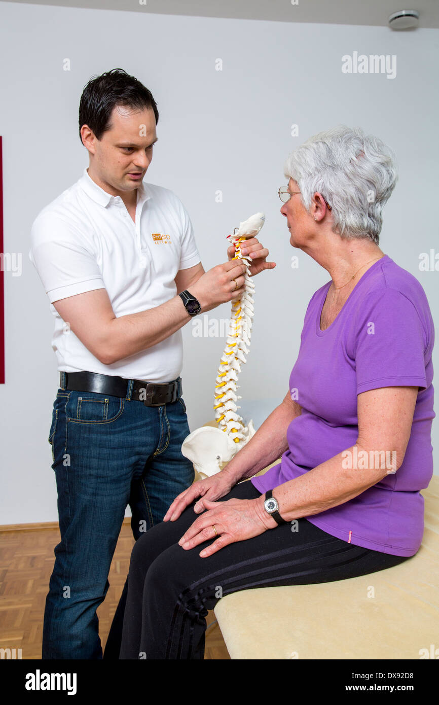 Physiotherapy practice therapist with patient explanation of the ...