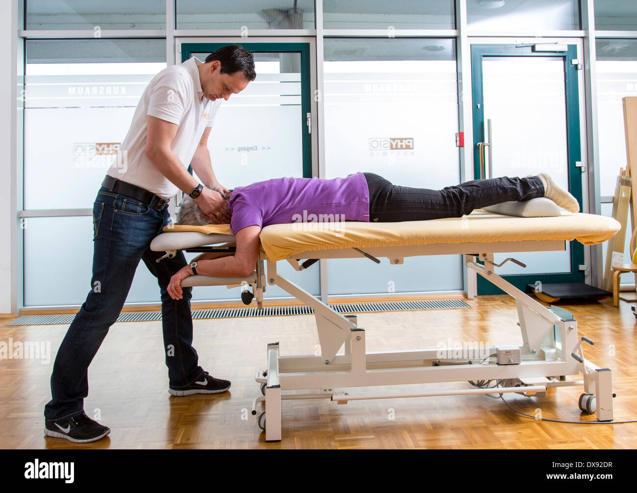 Physiotherapy practice therapist with patient mobilization of the ...