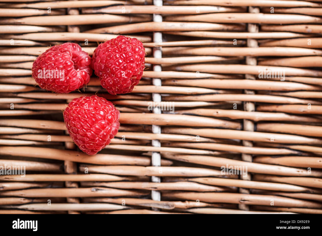 Three raspberry in the wicker tray Stock Photo - Alamy