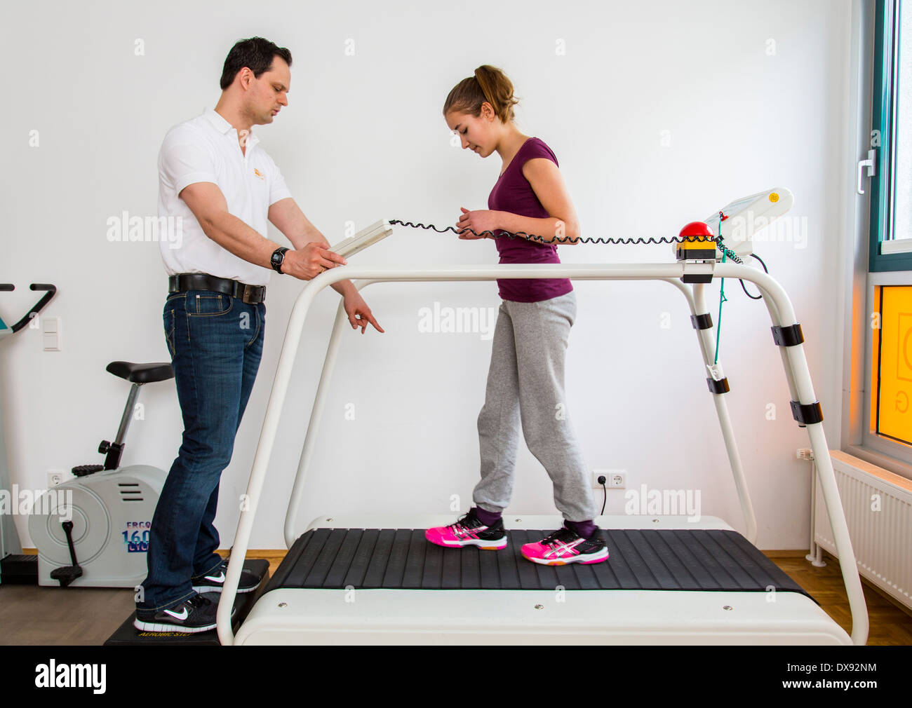 Physiotherapy practice therapist with patient, running training with ...