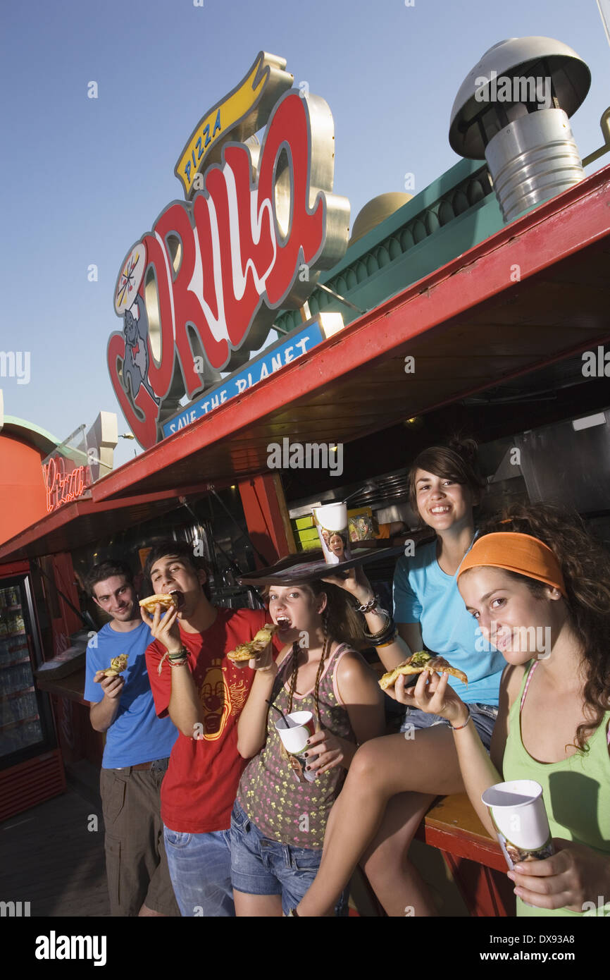 Teenagers hanging out, eating pizza Stock Photo - Alamy