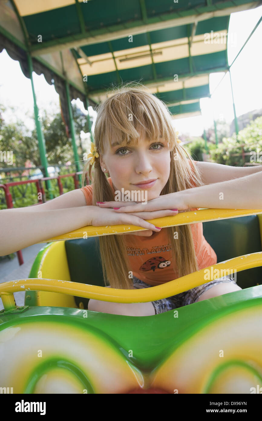 Female teenager posing at amusement park ride Stock Photo - Alamy