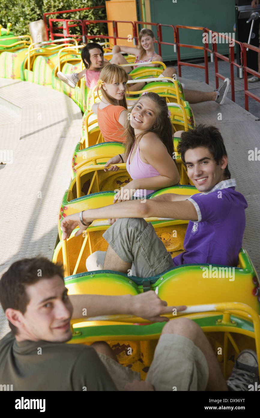 Teenagers posing on amusement park ride Stock Photo - Alamy