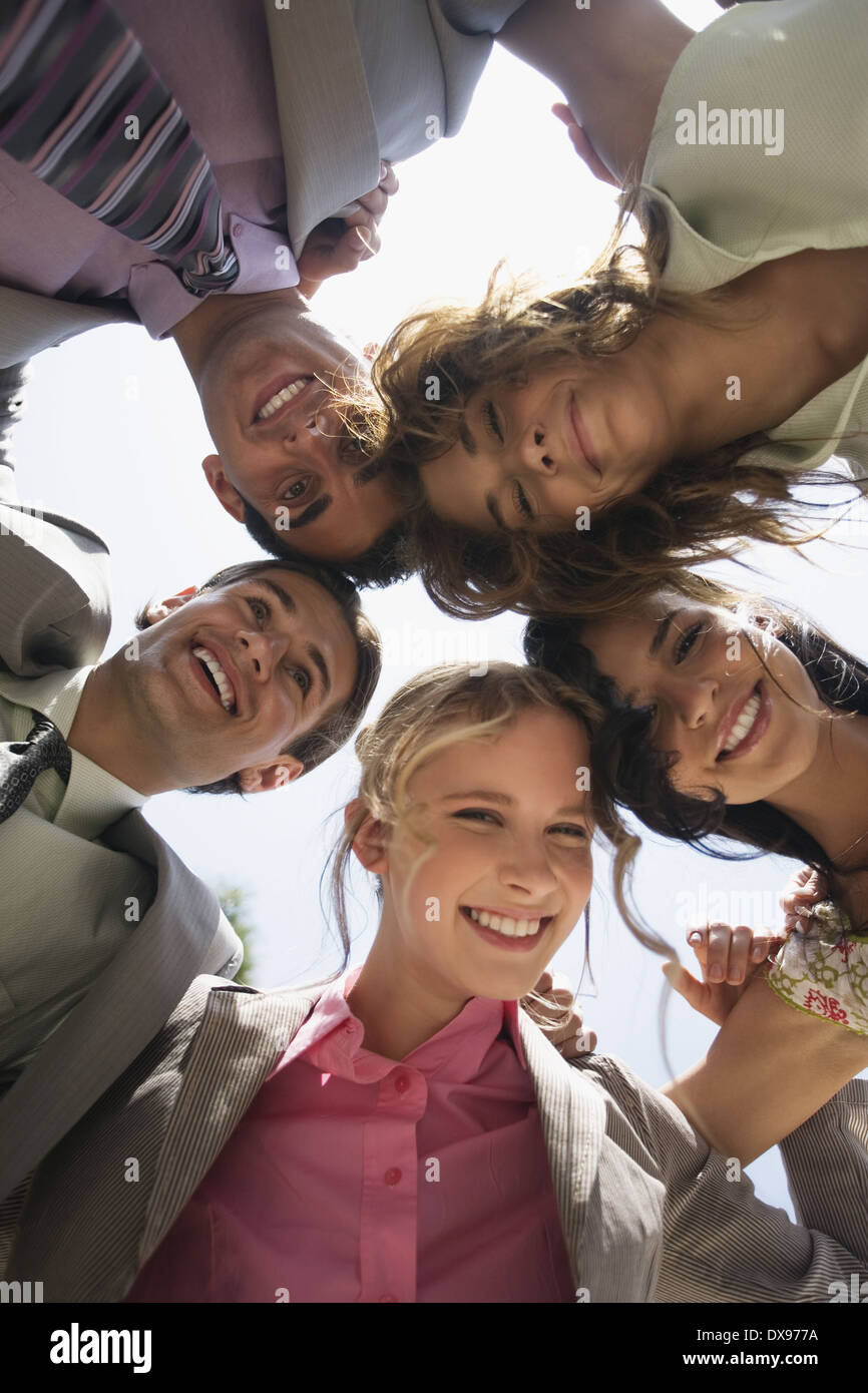 Group of business people with heads together Stock Photo - Alamy