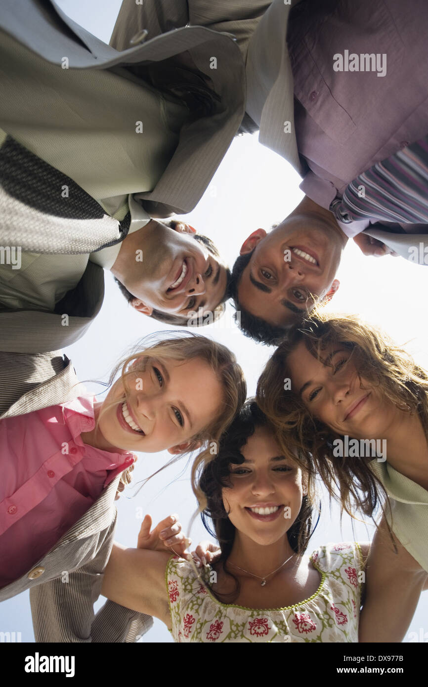 Group of business people with heads together Stock Photo - Alamy