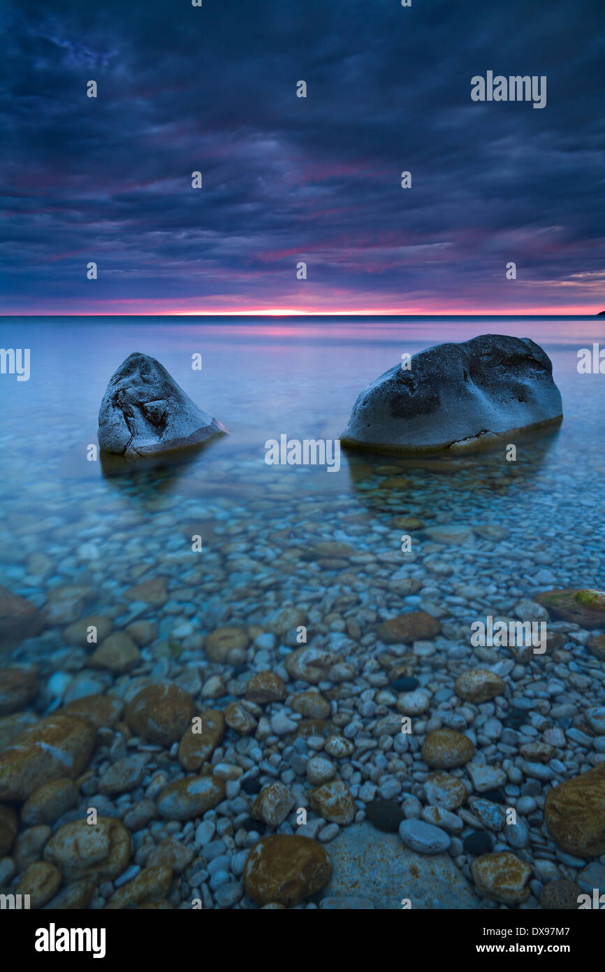 A dramatic photo of two large granite boulders sitting amongst a rocky ...