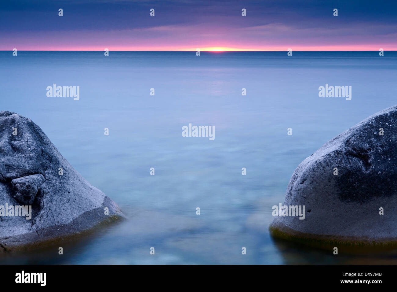 A dramatic photo of two large granite boulders sitting amongst a rocky ...
