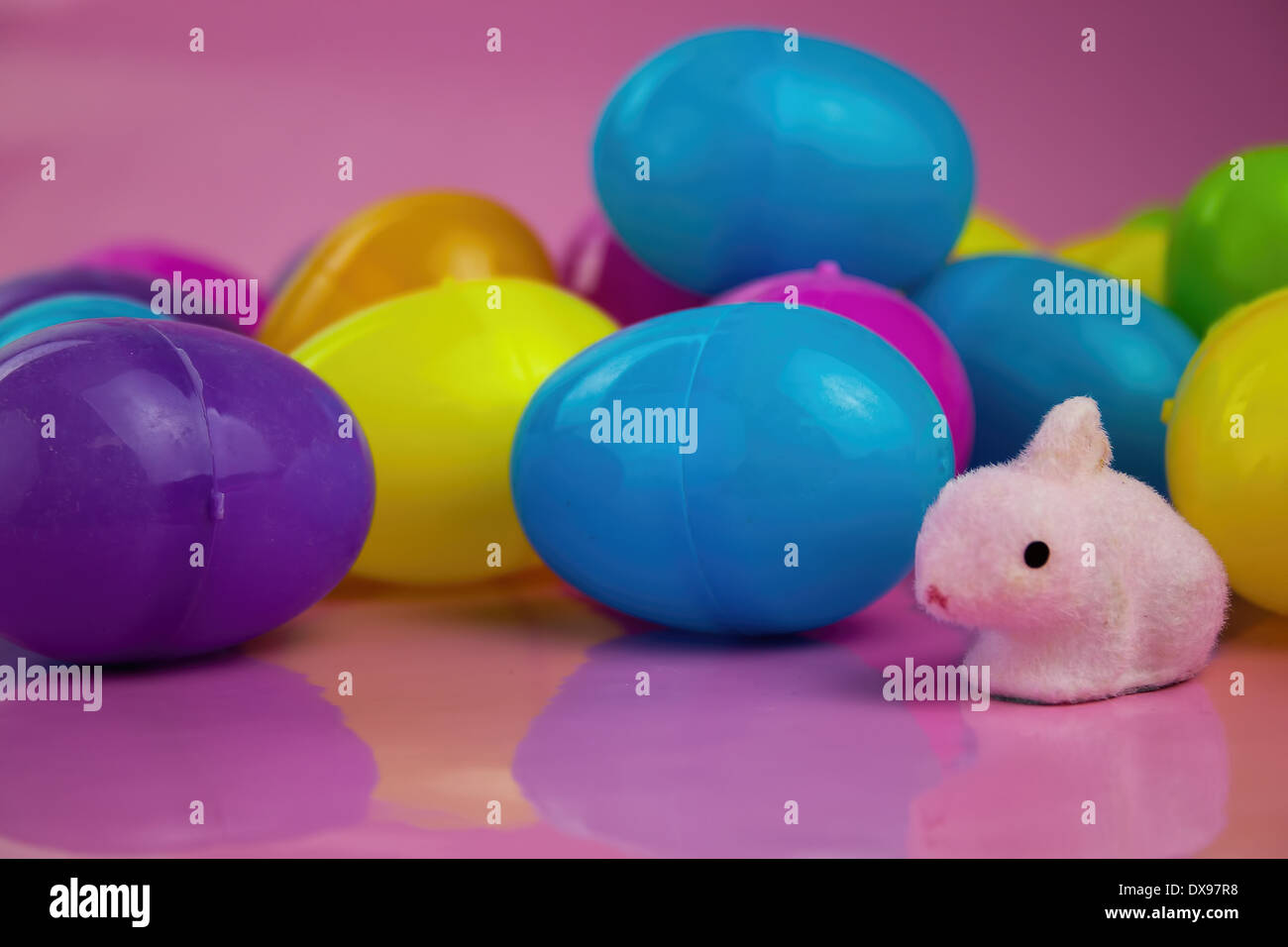 a group of Plastic Easter Egg shells on a glossy pink background. cute ...