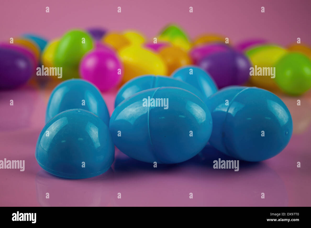 a group of Plastic Easter Egg shells on a glossy pink background. cute ...