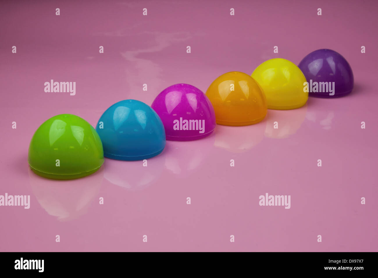 Six Plastic Easter Egg shells on a glossy pink background. cute ...