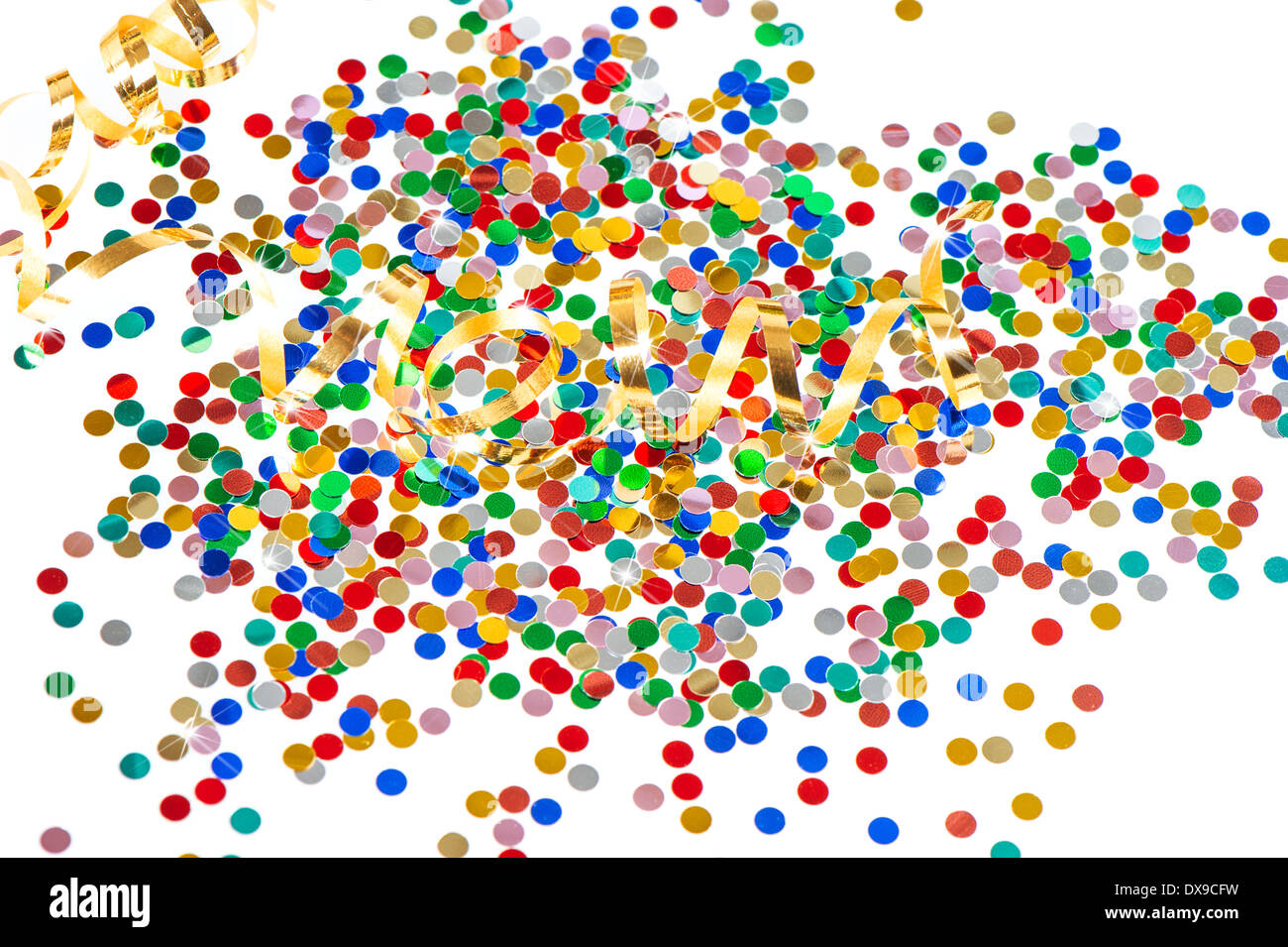 assorted confetti with golden serpentine streamer on white background ...