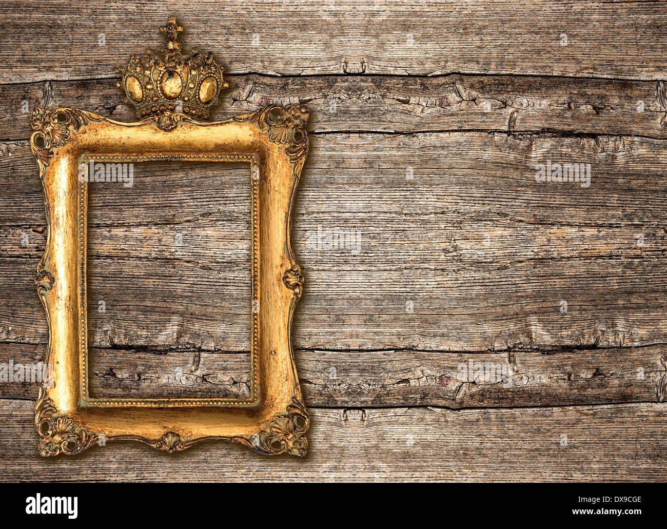 golden frame with crown over rustic wooden background Stock Photo - Alamy