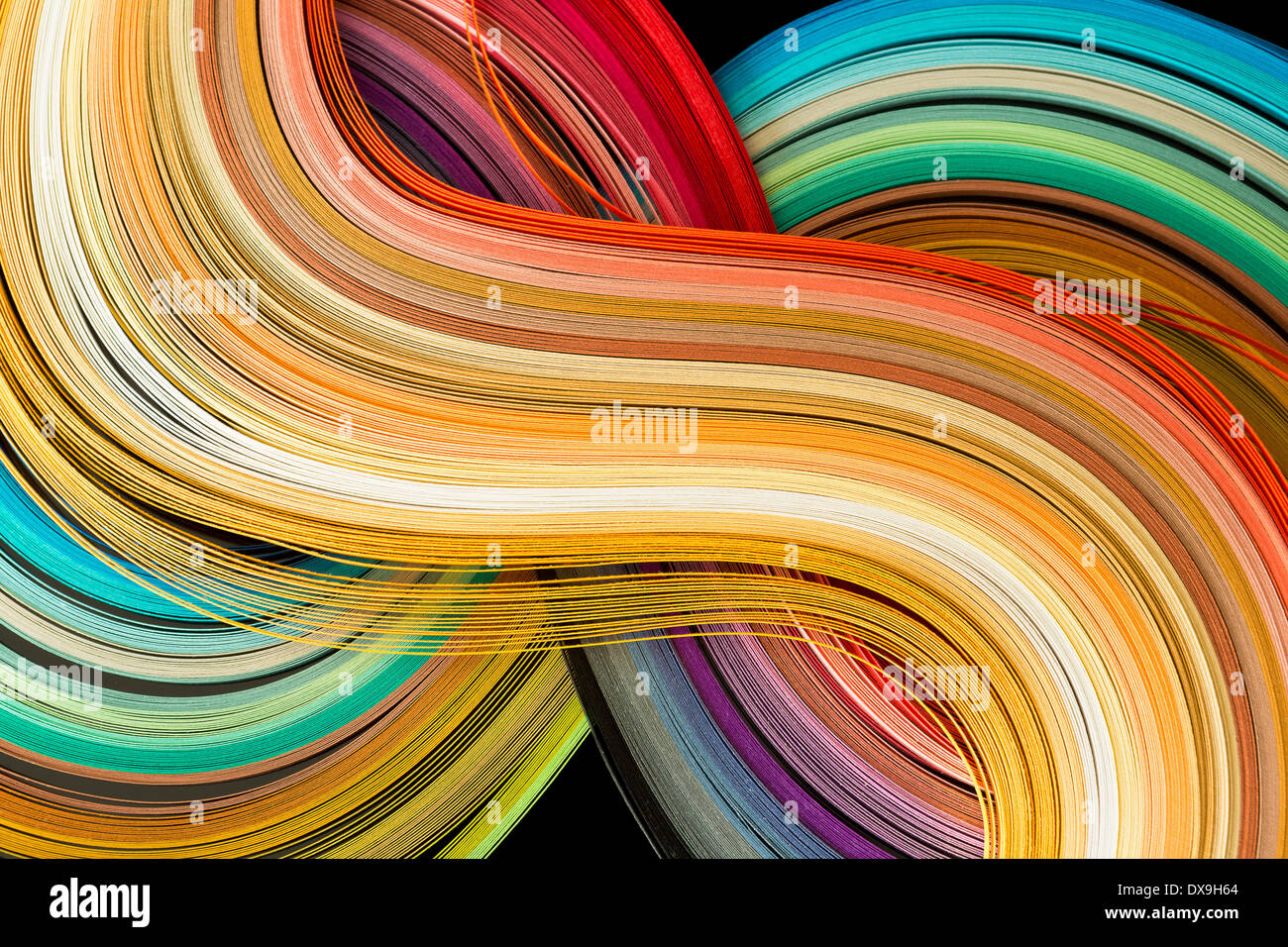 Rainbow colored filigree paper laid out in waves and shapes Stock Photo ...