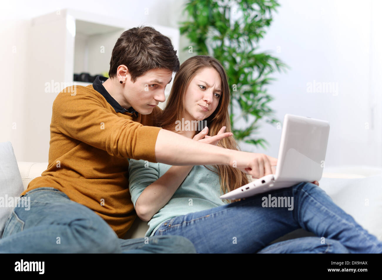Couple of lovers uses a computer with a worried attitude Stock Photo ...