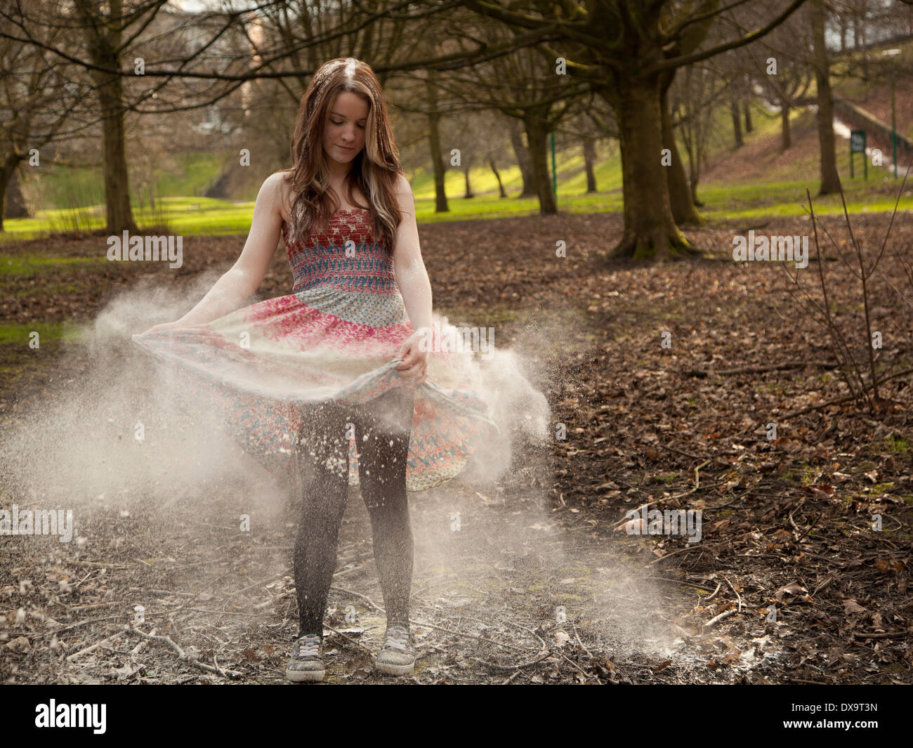 Girl dancing in flour in woods Stock Photo - Alamy