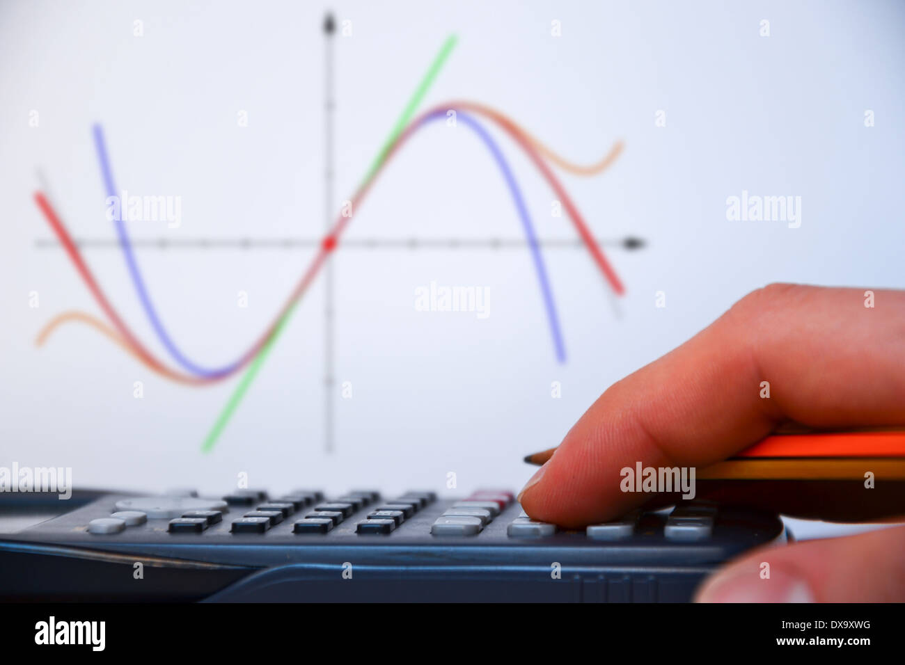 analyze data with calculator and pencil Stock Photo - Alamy