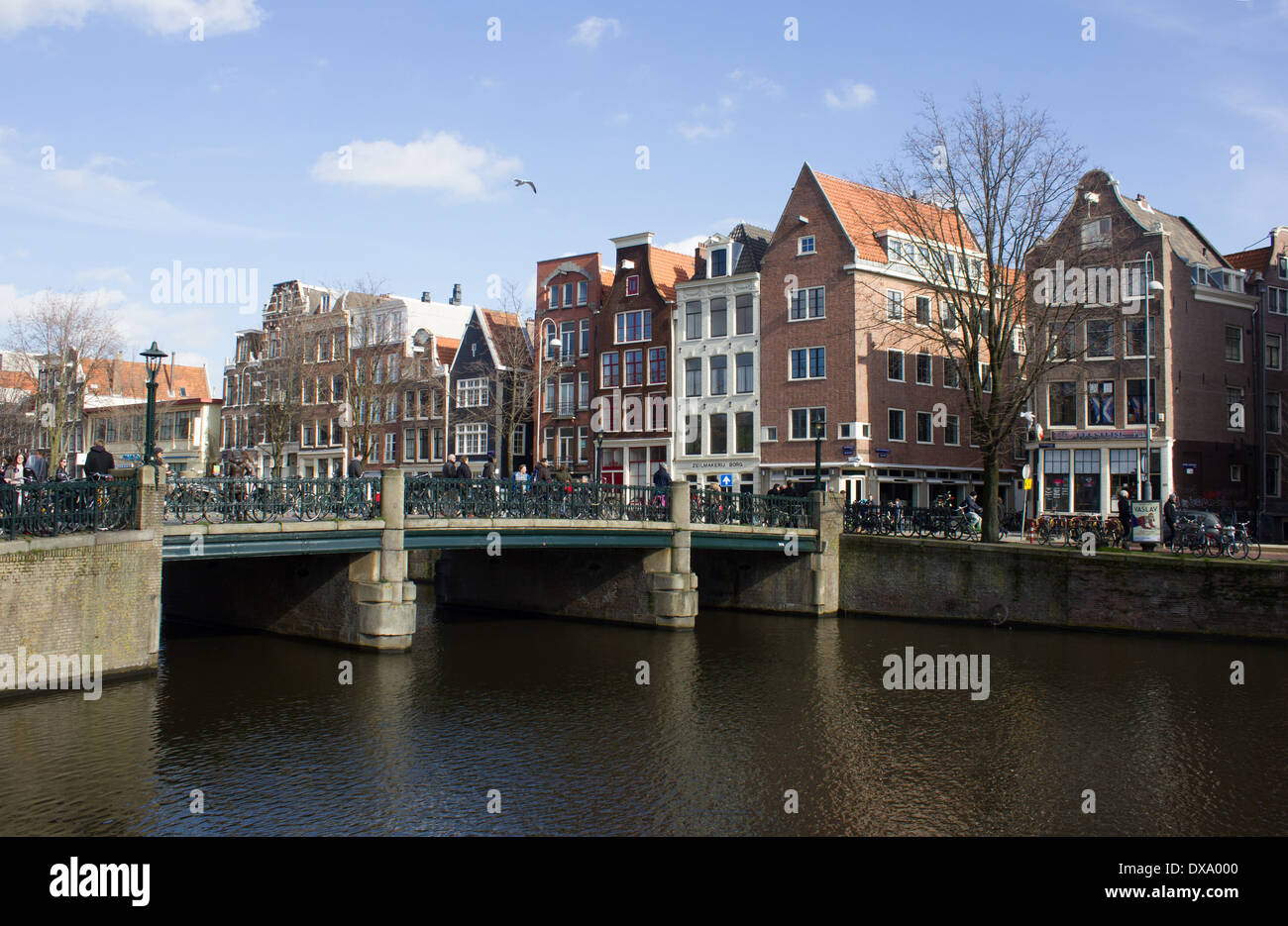 Dutch canal bridge with bicycles and traditional buildings Amsterdam ...