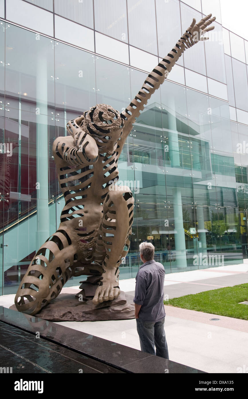 man looking at statue outside canberra international airport terminal ...