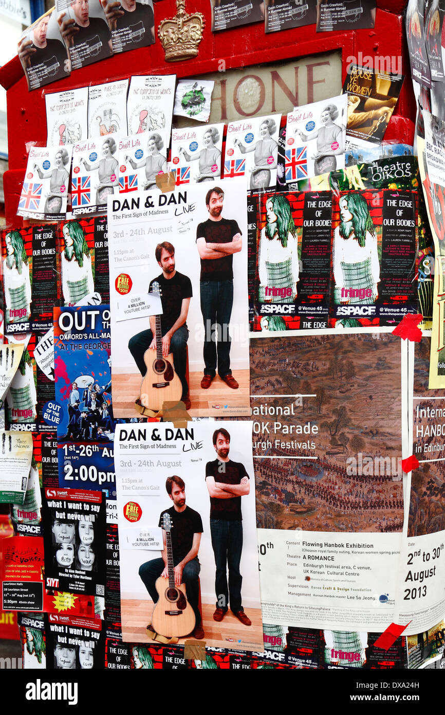 A telephone box covered in posters advertising shows at the Edinburgh ...