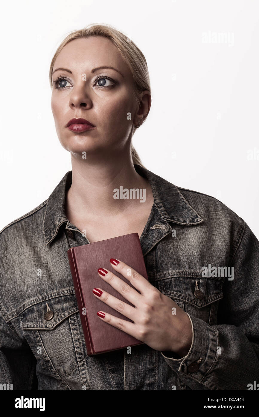 Blonde Woman Holding Old Hardcover Book To Her Chest Looking Up In A