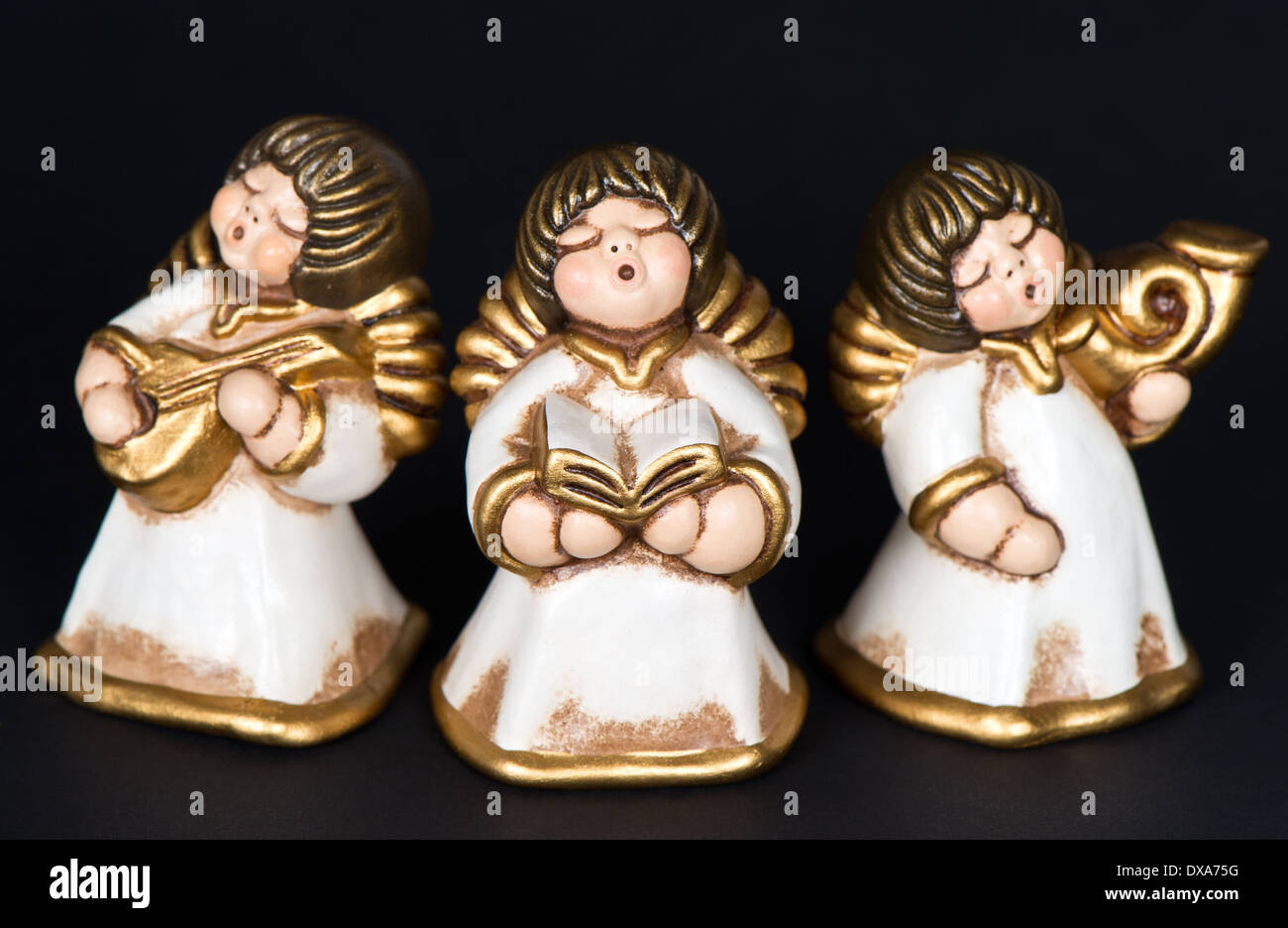 cute singing angels on black background Stock Photo - Alamy