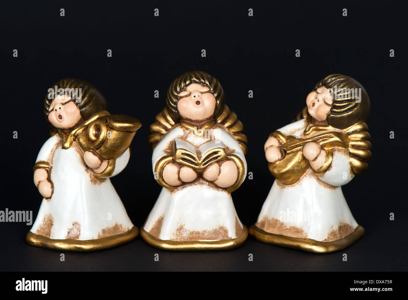 cute singing angels on black background Stock Photo - Alamy