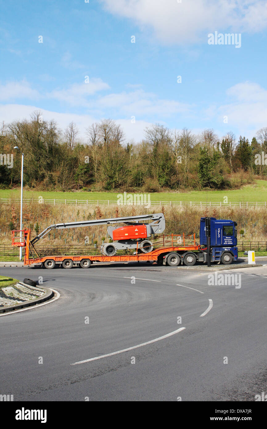 An unmarked articulated low loader exiting a roundabout in Coulsdon ...