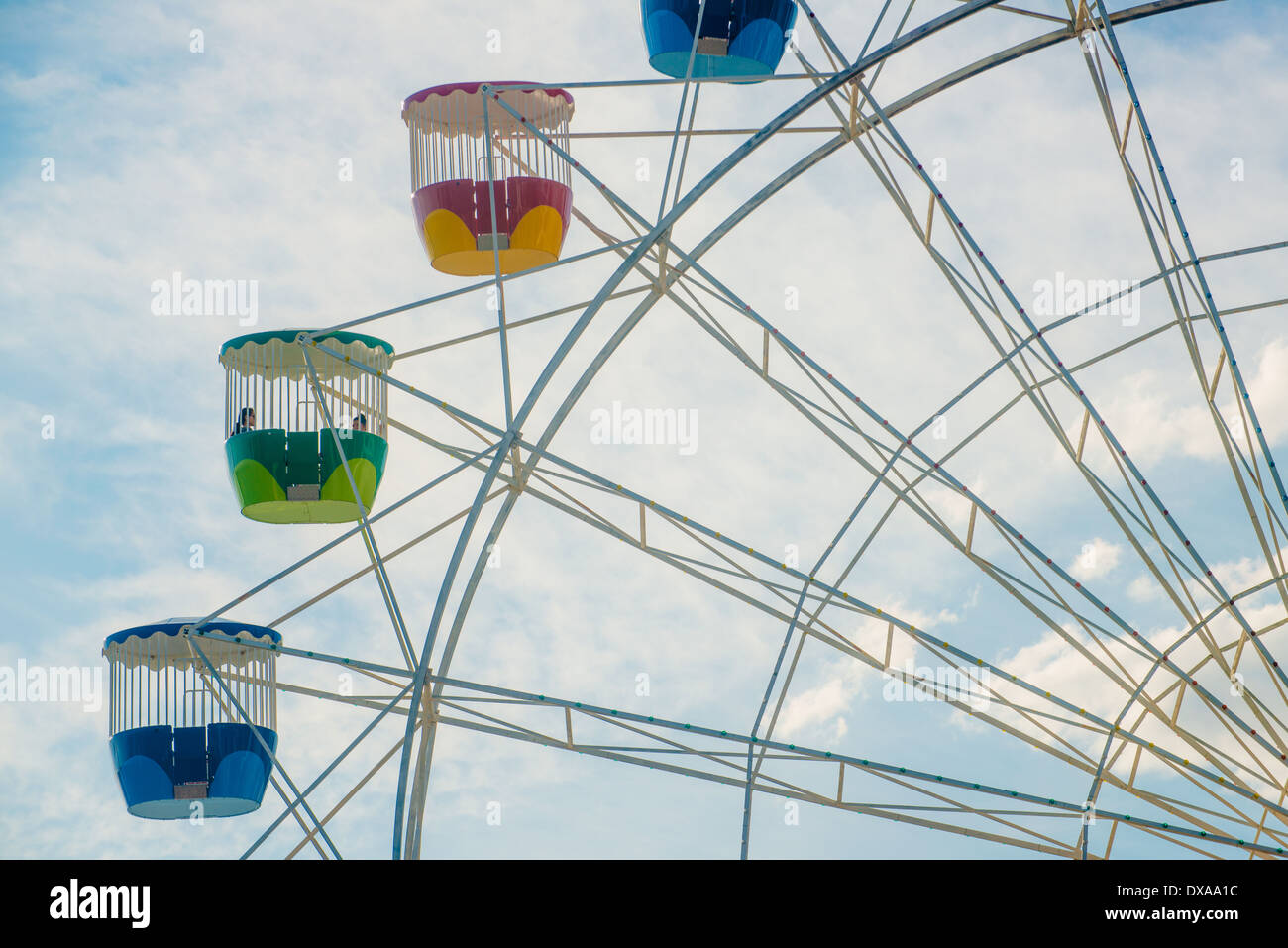 This is an image of a ferris wheel at a amusement park on a sunny day ...