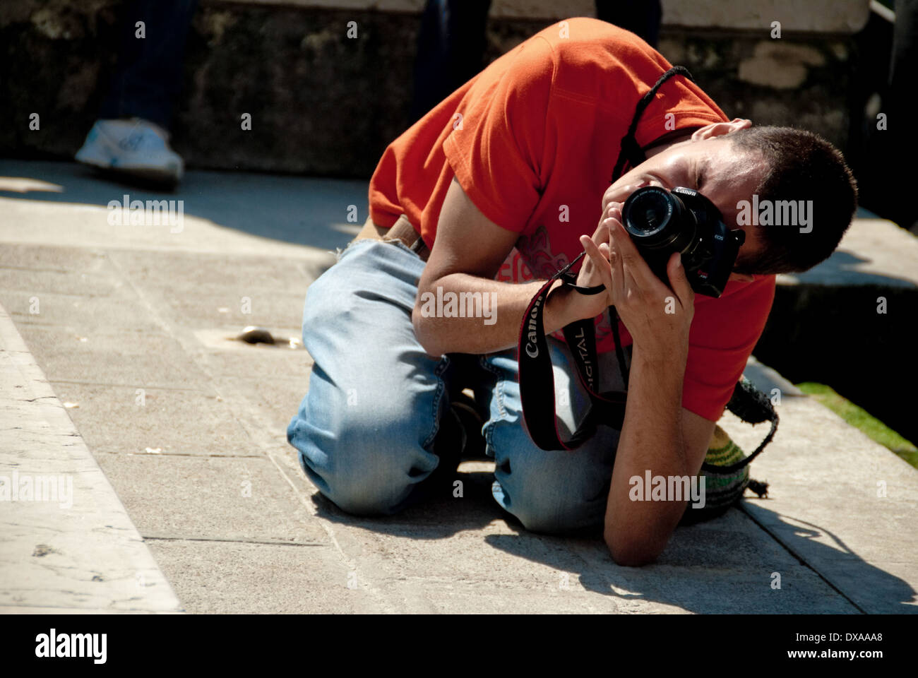 Man sitting on the ground while taking a photo Stock Photo - Alamy