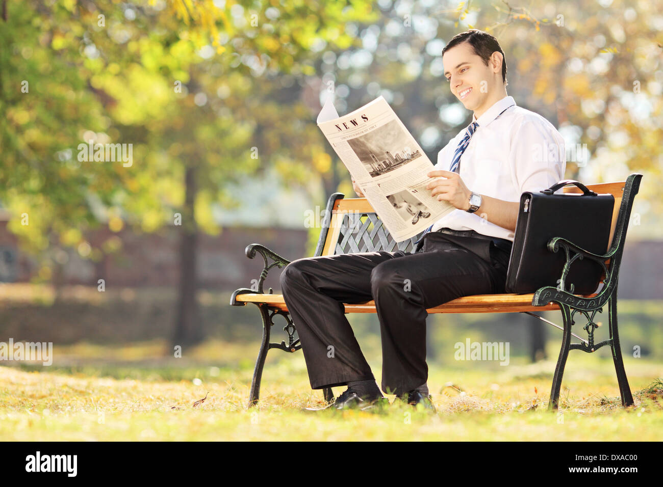 Businessman outdoors in park newspaper hi-res stock photography and ...